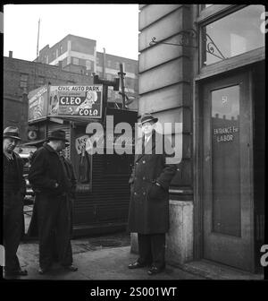 Cincinnati, Ohio, USA. circa 1937. People; man searching through ...