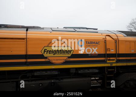 Class 66 diesel locomotive No. 66413 "Lest we forget" pulling a ...