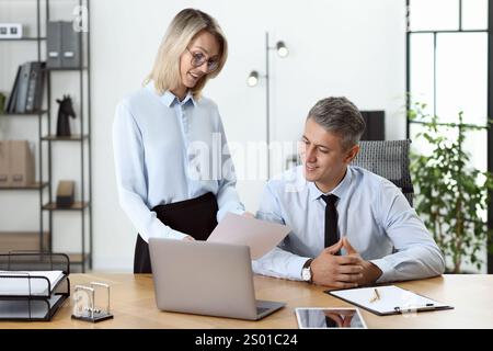 Middle aged employees working together in office Stock Photo - Alamy
