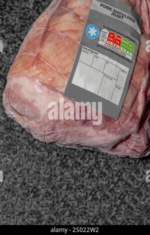 Vacuumed packed frozed pork shoulder joint of meat with a food retail ...