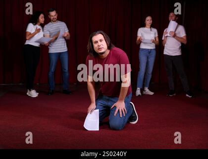 Professional actors with their scripts rehearsing in theatre Stock ...