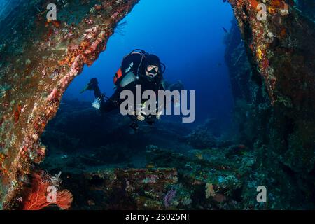 Underwater photographer on the ww2 shipwreck USAF Liberty at Tulamben ...