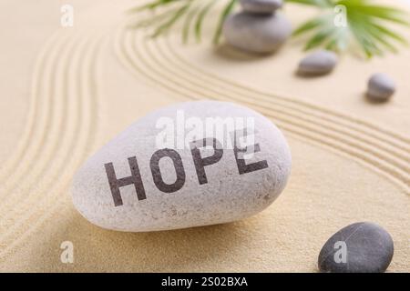 Hope. Zen garden stones on white sand with pattern Stock Photo - Alamy