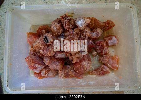 Processed meat cut into cubes is placed in a container Stock Photo - Alamy