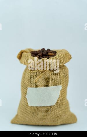 A burlap sack tightly filled with roasted coffee beans, standing ...