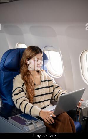 woman using a computer and earphone during a video conference Stock ...