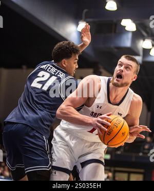 Utah State center Aubin Gateretse (21) shoots as Air Force guard Chase ...