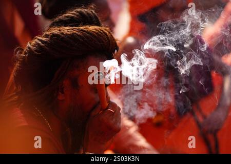 A Hindu holy man smokes marijuana at his makeshift living quarters at ...