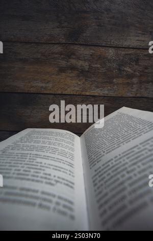 vintage old open book with some visible pages lying on top of other ...