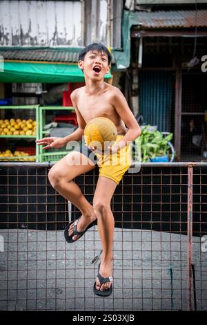 Young Filipino boys play basketball on Asuncion St. Tondo, Manila The ...