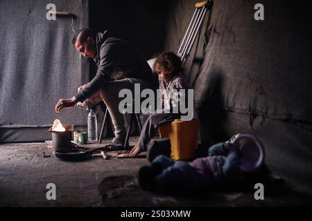Palestinian displaced person Riyad Abu Sharkh, 26 years old, sits with ...