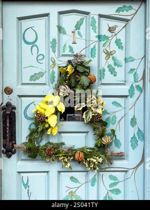 Beautiful wreath made of pine cones and acorns on white wooden ...