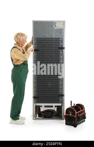 Female worker repairing refrigerator on white background Stock Photo ...