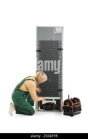 Female worker repairing refrigerator on white background Stock Photo ...