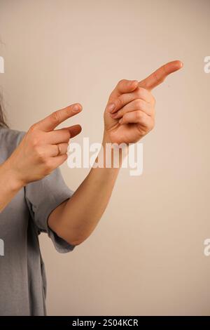Hands showing a double pointing gesture, directed in opposite ways. The ...