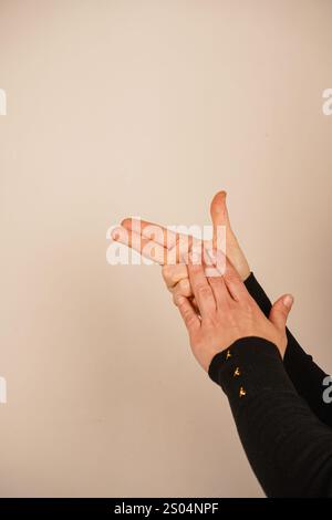 Fingers are arranged to mimic the shape of a gun, creating a playful ...