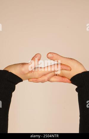 Two hands interlock their fingers to form a closed pose. This powerful ...