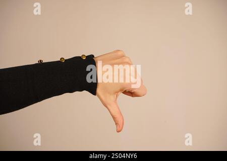 With the thumb pointed down, the hand conveys a strong sense of ...