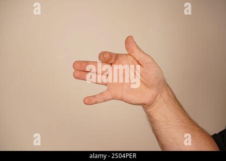 The hand gesture mimics the open mouth of a dog, combining whimsy and ...