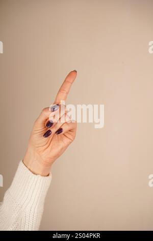 The index finger points forward with intent, drawing attention to ...