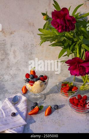 Bowl of fresh strawberries served with natural white cream on a wooden ...