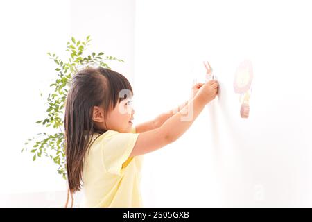 Child applying stickers Stock Photo - Alamy