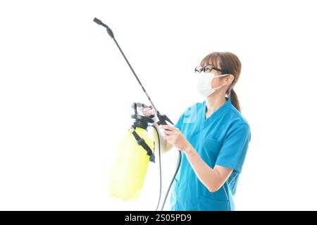 Medical personnel spraying disinfectant solution Stock Photo - Alamy