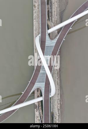 HANGZHOU, CHINA - DECEMBER 25, 2024 - A scenic pedestrian bridge across ...