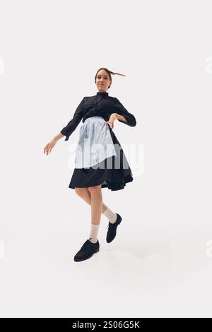 Excited waiter in black apron pointing fingers down, checking out promo ...