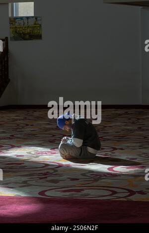 A devout Sikh worshipper in prayer and meditation inside a shaft of ...