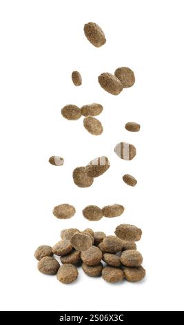 Dry pet food falling onto heap on white background Stock Photo - Alamy
