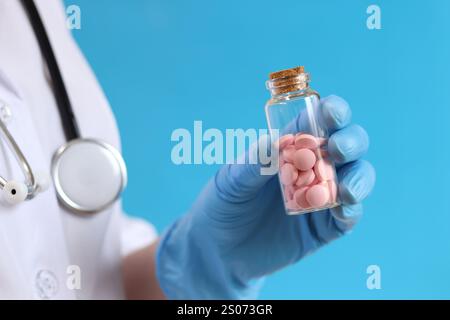Female doctor with vitamins on pink background Stock Photo - Alamy
