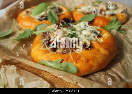 Delicious mini pizza with mushrooms, beef, melted cheese, and fresh ...