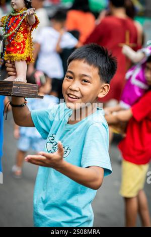 Filipino people celebrate an annual religious festival with a parade ...