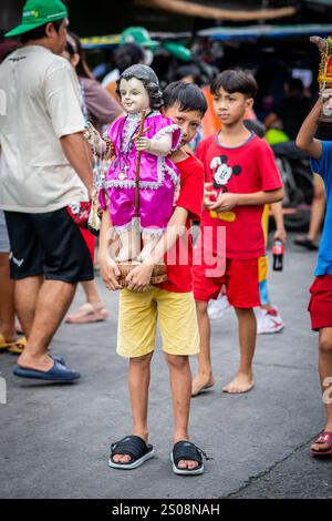 Filipino people celebrate an annual religious festival with a parade ...