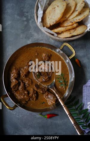 Lamb curry served with Ney Pathal | Kerala breakfast meal Stock Photo ...