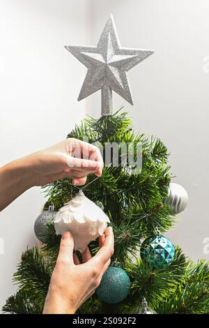 hands decorating christmas tree with ball Stock Photo - Alamy