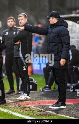 Salford, UK. 26th Dec 2024. Stephen Negru of Salford City FC holds off ...
