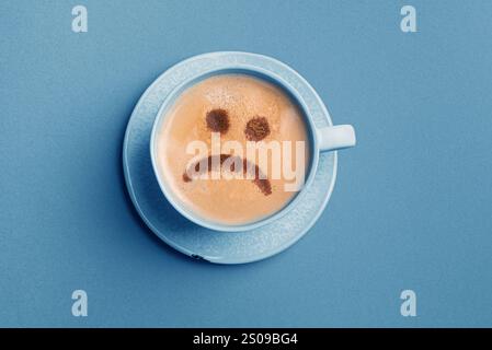 Upset face on coffee foam. Blue Monday. Seasonal depression or disorder ...