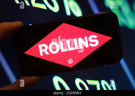 In this photo illustration the Rollins logo seen displayed on a ...
