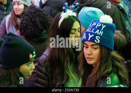 A young woman wears a hat saying "Happy Challah Days." Hundreds of ...