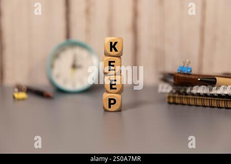 Keep it simple words on wooden blocks on dark gray background. Business ...