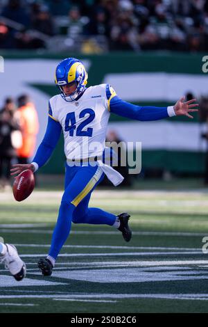 Los Angeles Rams punter Ethan Evans (42) holds the ball while kicker ...