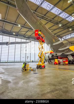 technician in the hangar with the plane Stock Photo - Alamy