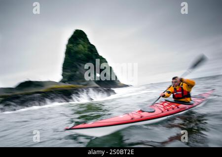 Todd Van Raden braves a 10 foot swell as he sea kayaks around the sea ...