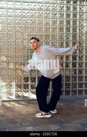 A young man poses against a glass block wall Stock Photo - Alamy
