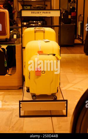 Bright yellow luggage exhibits display in a modern retail store ...