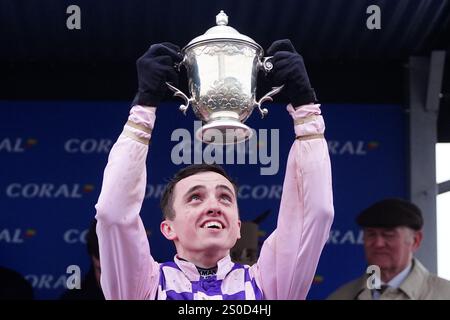 Jockey Charlie Hammond poses for a photo with the trophy after winning ...