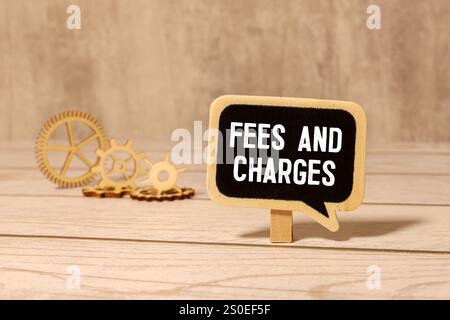 Fees and charges message written on ripped torn paper piece with red ...