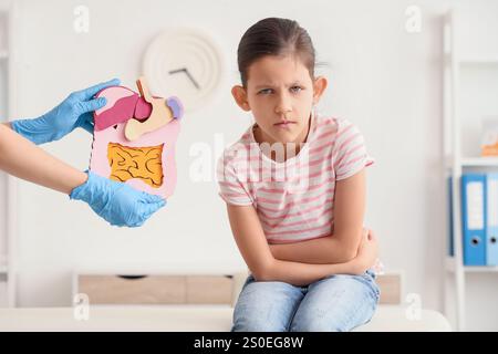 Teenage girl with appendicitis and doctor holding paper digestive ...